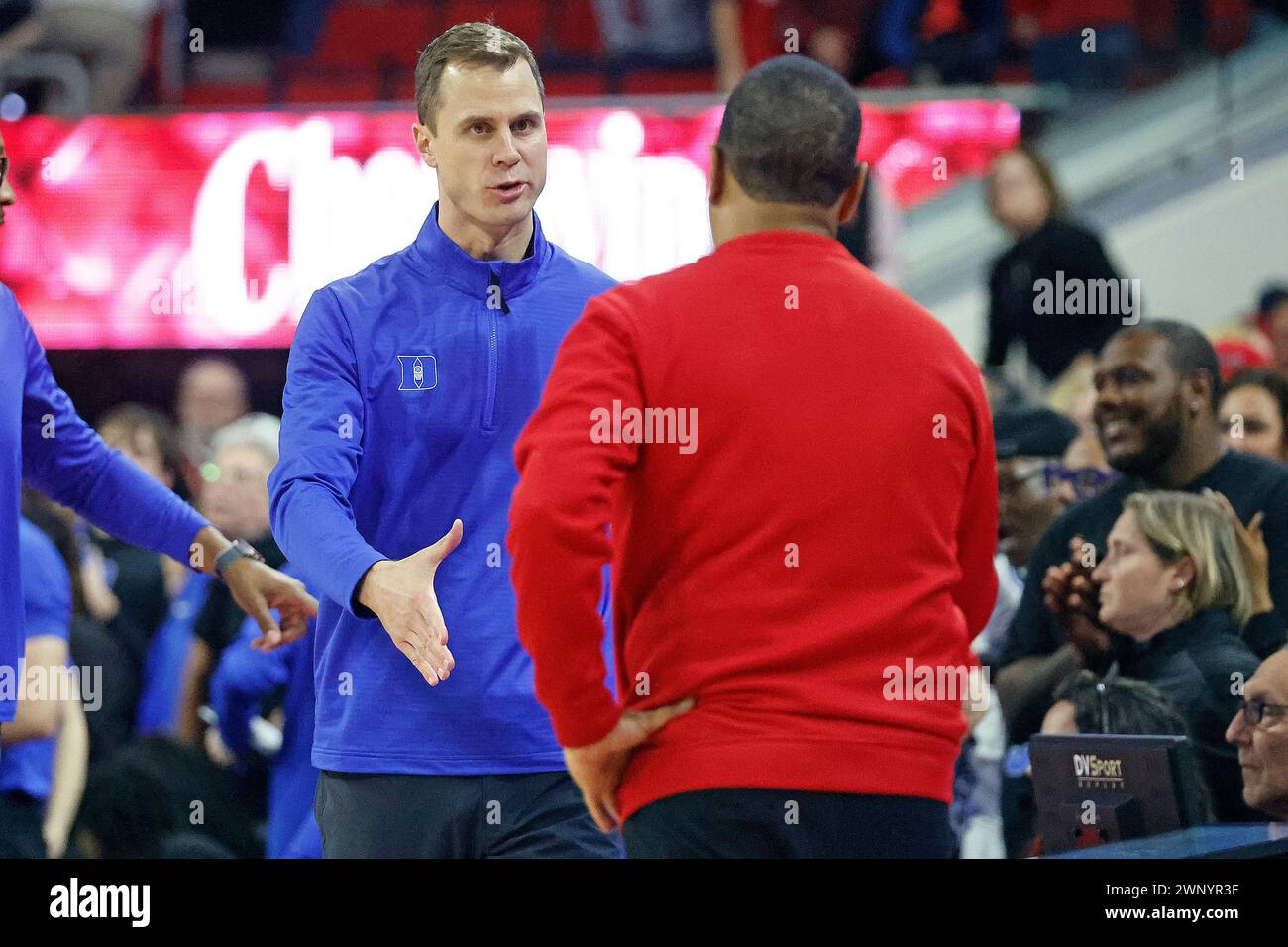 Duke head coach Jon Scheyer shakes hands with North Carolina State head ...