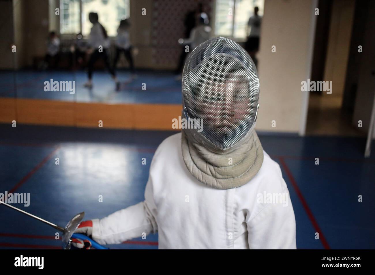 Odessa, Ukraine. 02nd Mar, 2024. A young fencer in a shield helmet seen ...