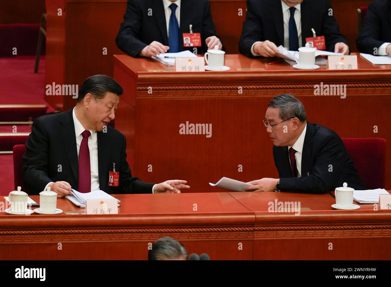 Chinese President Xi Jinping, left, talks with Chinese Premier Li Qiang ...