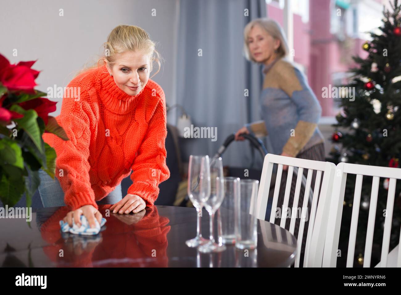 Woman cleaning table with rag at home before christmas Stock Photo - Alamy