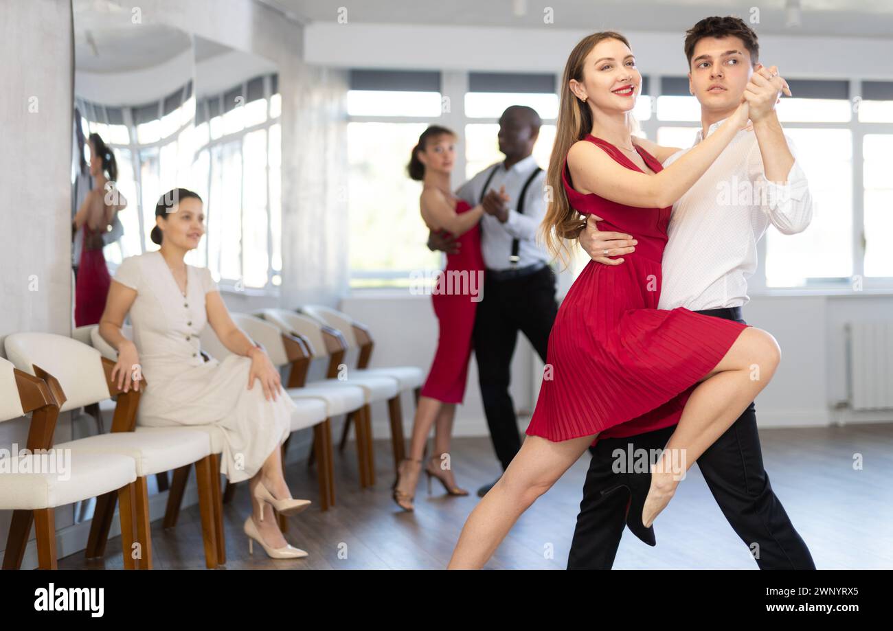 Young guy and graceful woman rehearsing elegant tango in pair Stock Photo - Alamy