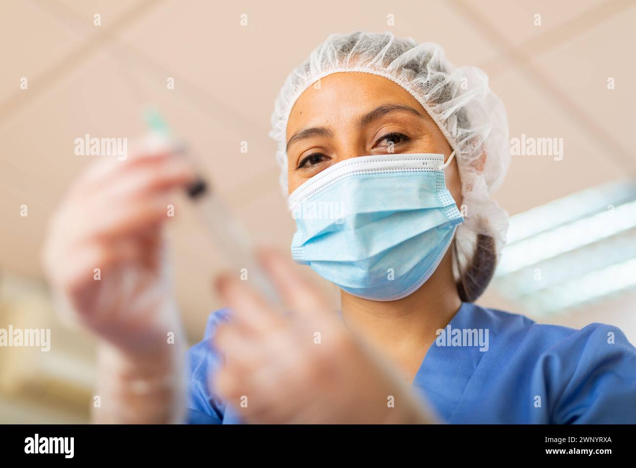Positive woman healthcare worker holding syringe for injection Stock ...