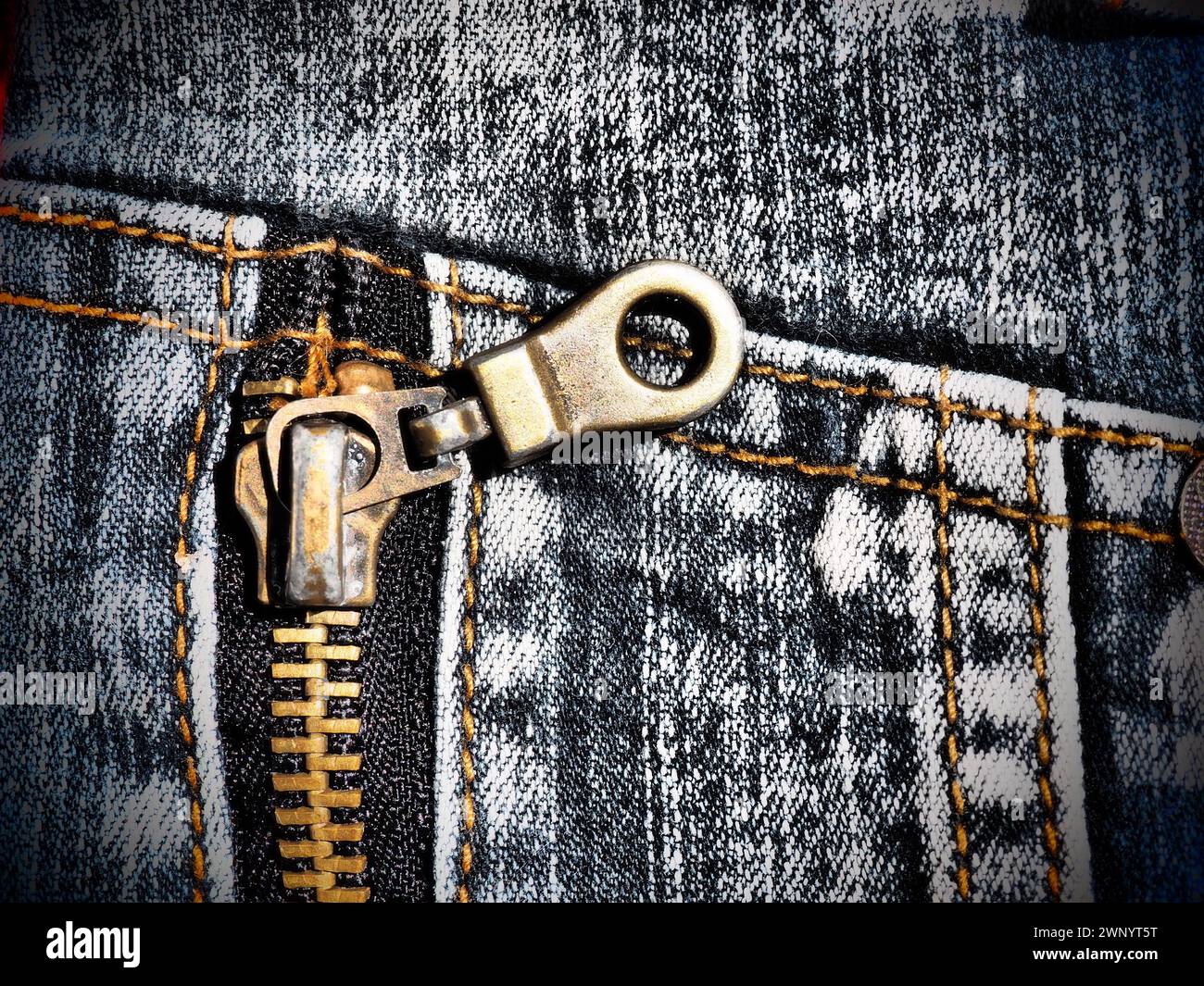 Close-up denim with seams and locks. Heavily shabby worn jeans. Metal ...