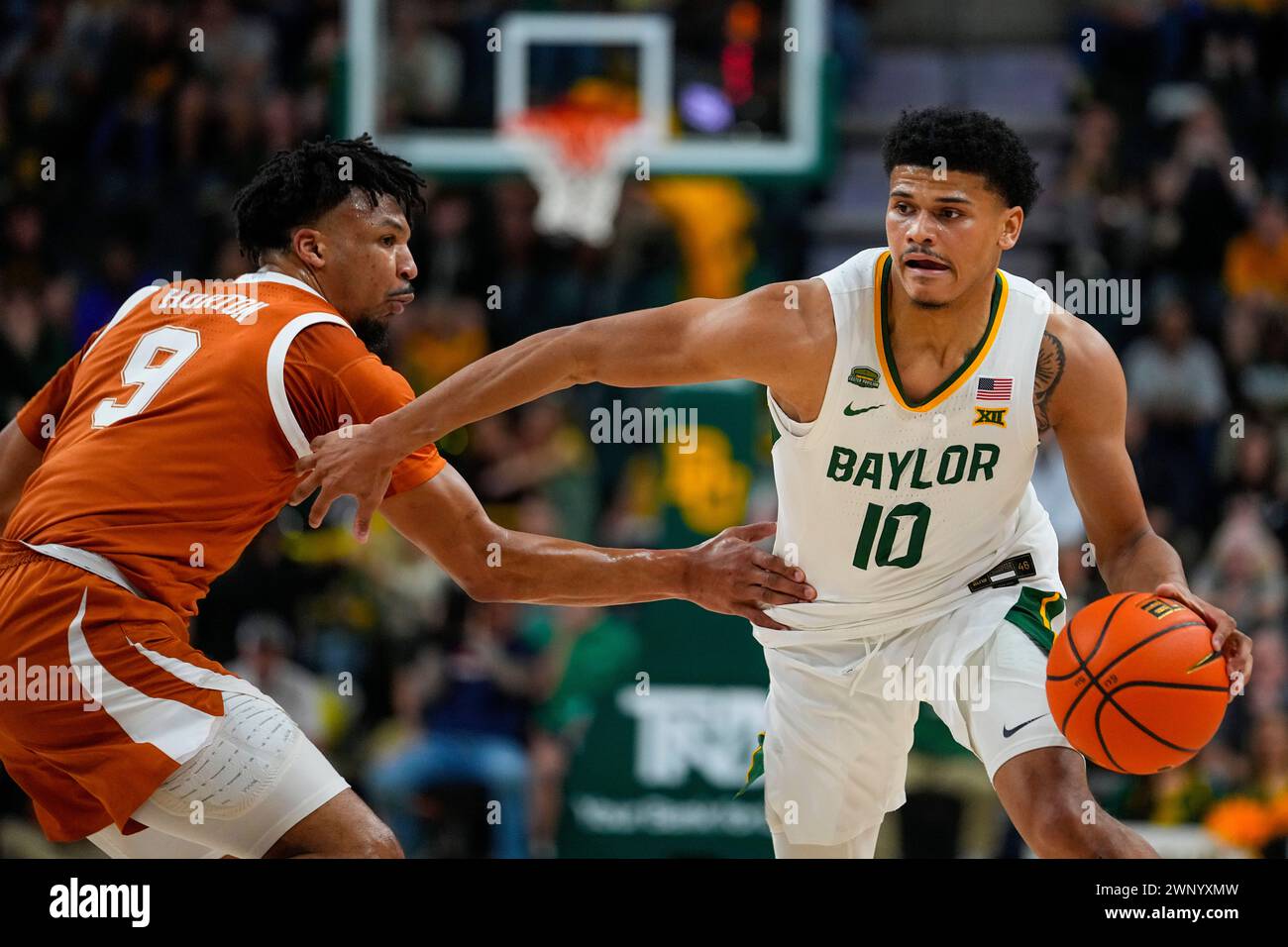 Baylor's RayJ Dennis (10) drives against Texas's Ithiel Horton (9 ...