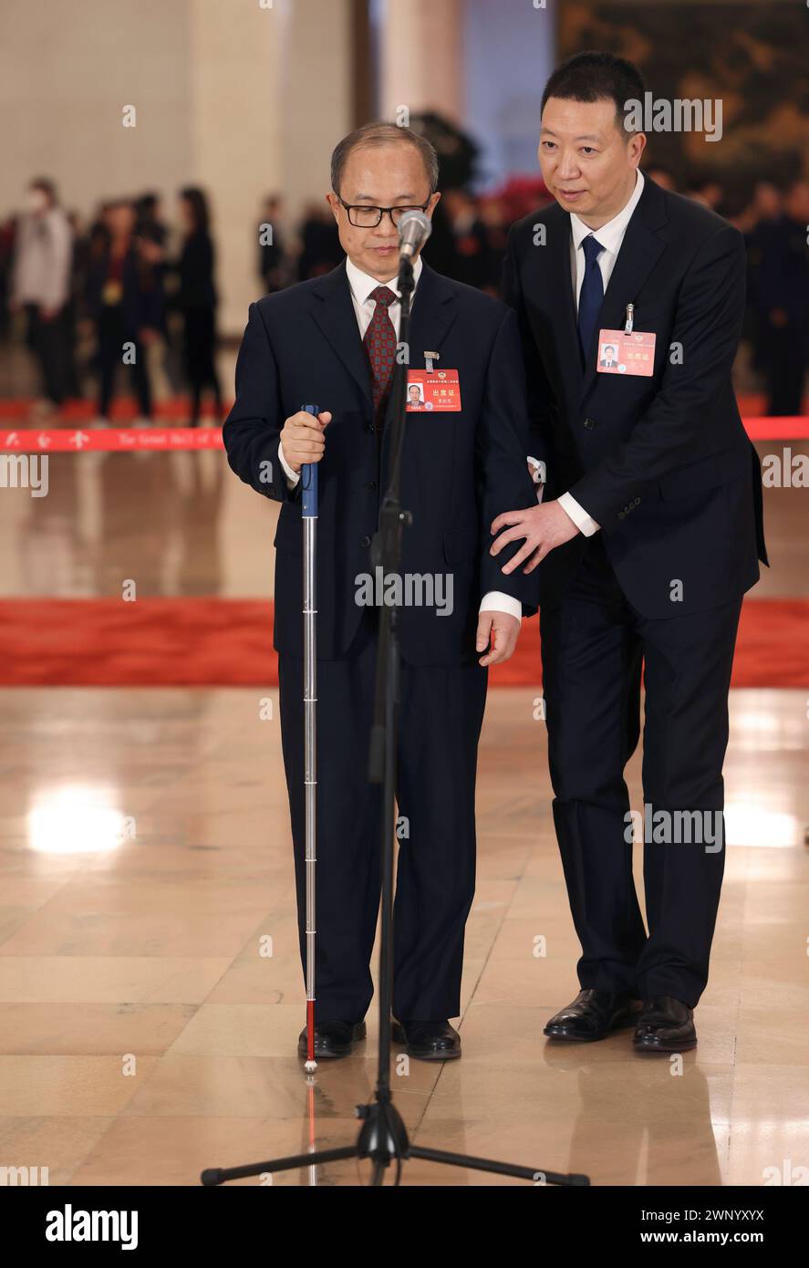 Beijing, China. 4th Mar, 2024. Li Qingzhong (L), a member of the 14th ...