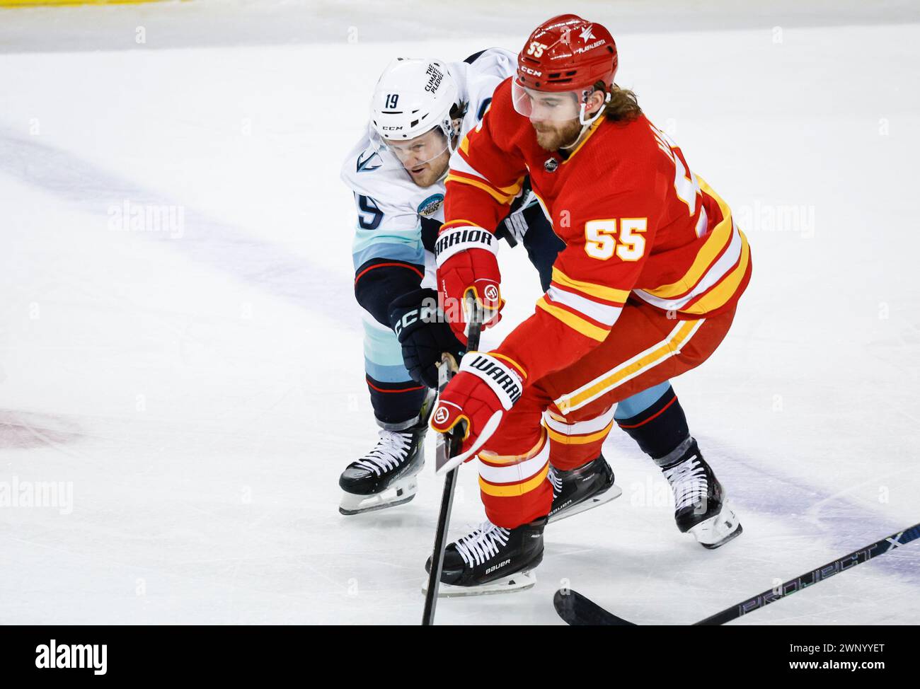 Seattle Kraken forward Jared McCann (19) checks Calgary Flames ...