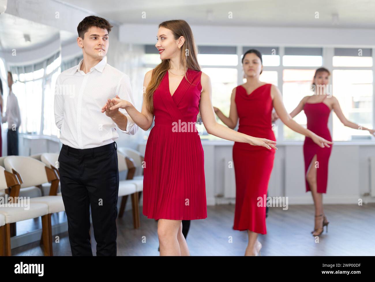 Young positive multinational people dancing together slow ballroom ...