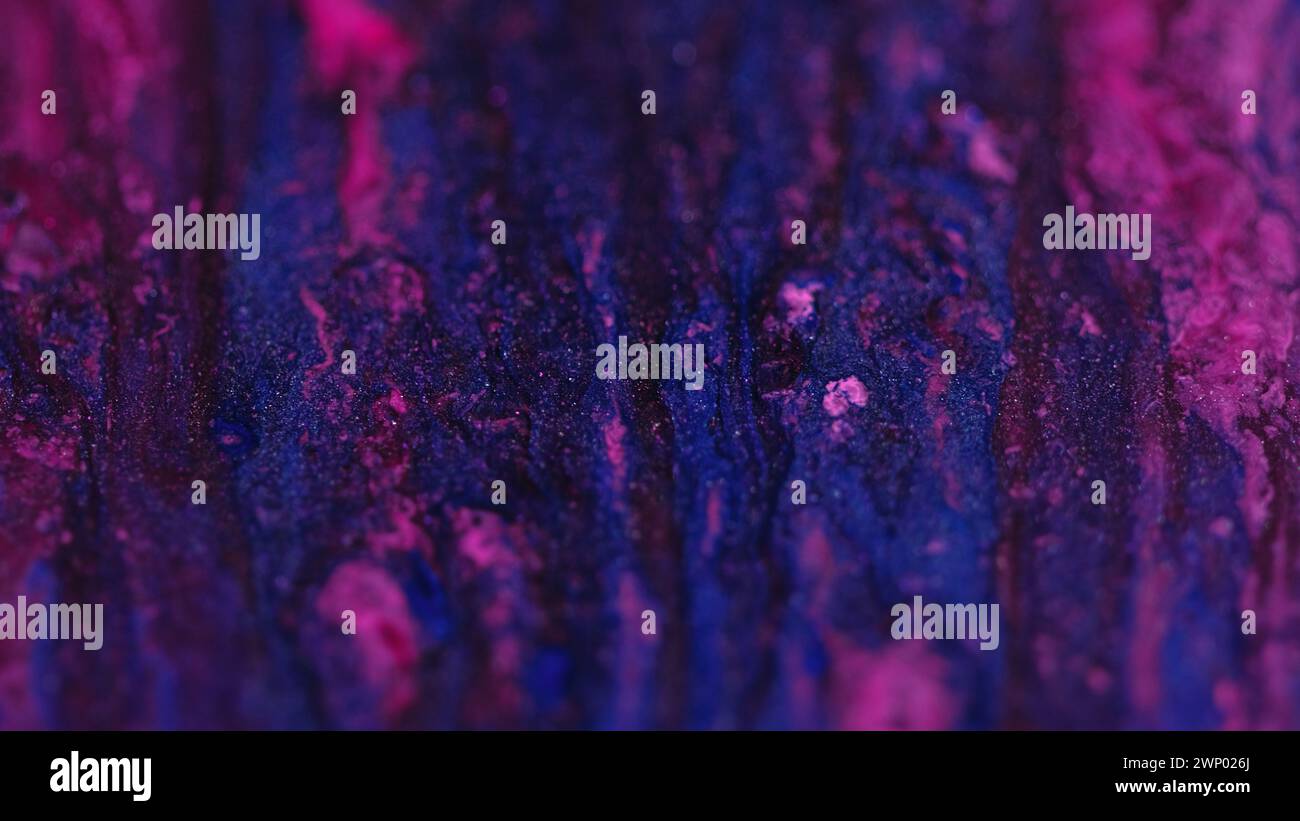 Shimmering paint drip ink flow blue pink fluid mix Stock Photo - Alamy