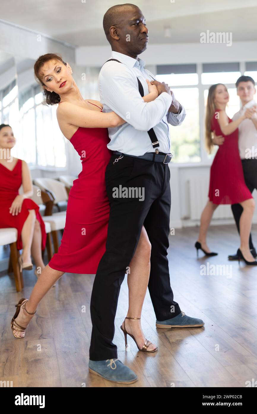 African man and woman dancing tango in couple during lesson at studio Stock Photo - Alamy