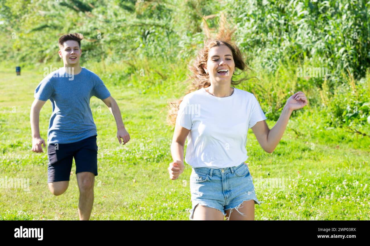 Two teenagers running boy girl hi-res stock photography and images - Alamy