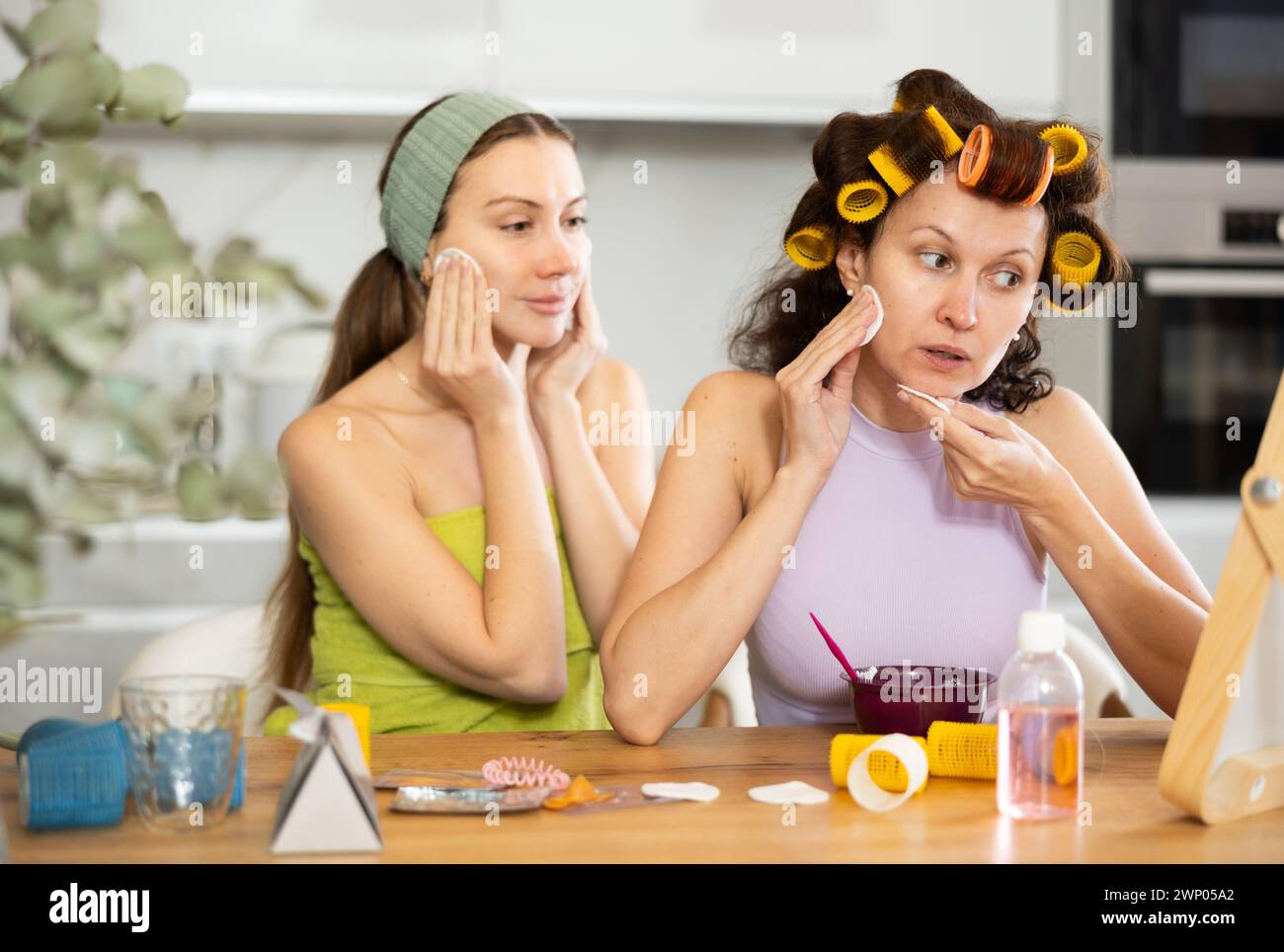 Two women cleanse their face with cotton pads Stock Photo - Alamy