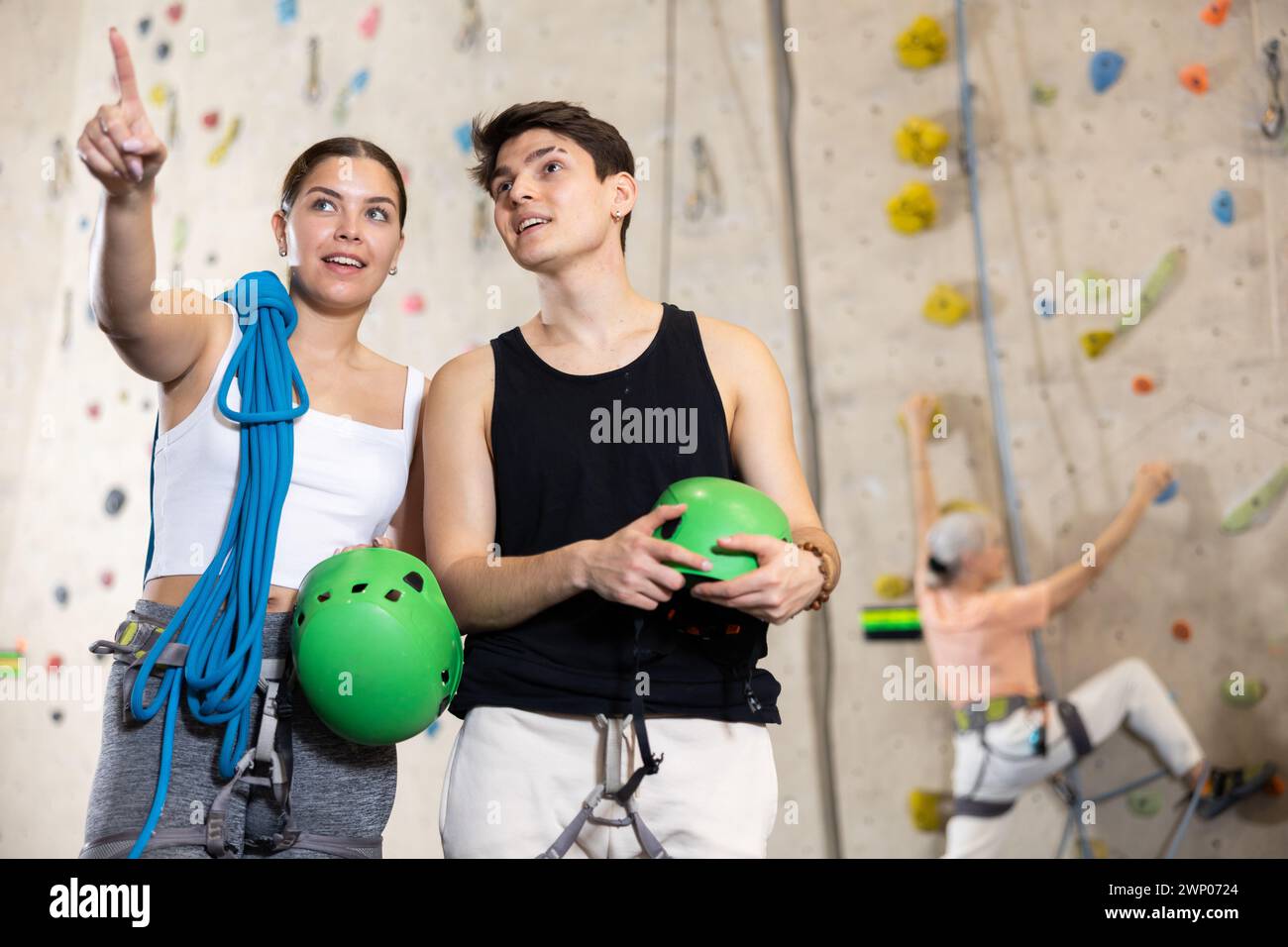 Happy excited young male and female visitors discussing upcoming ...