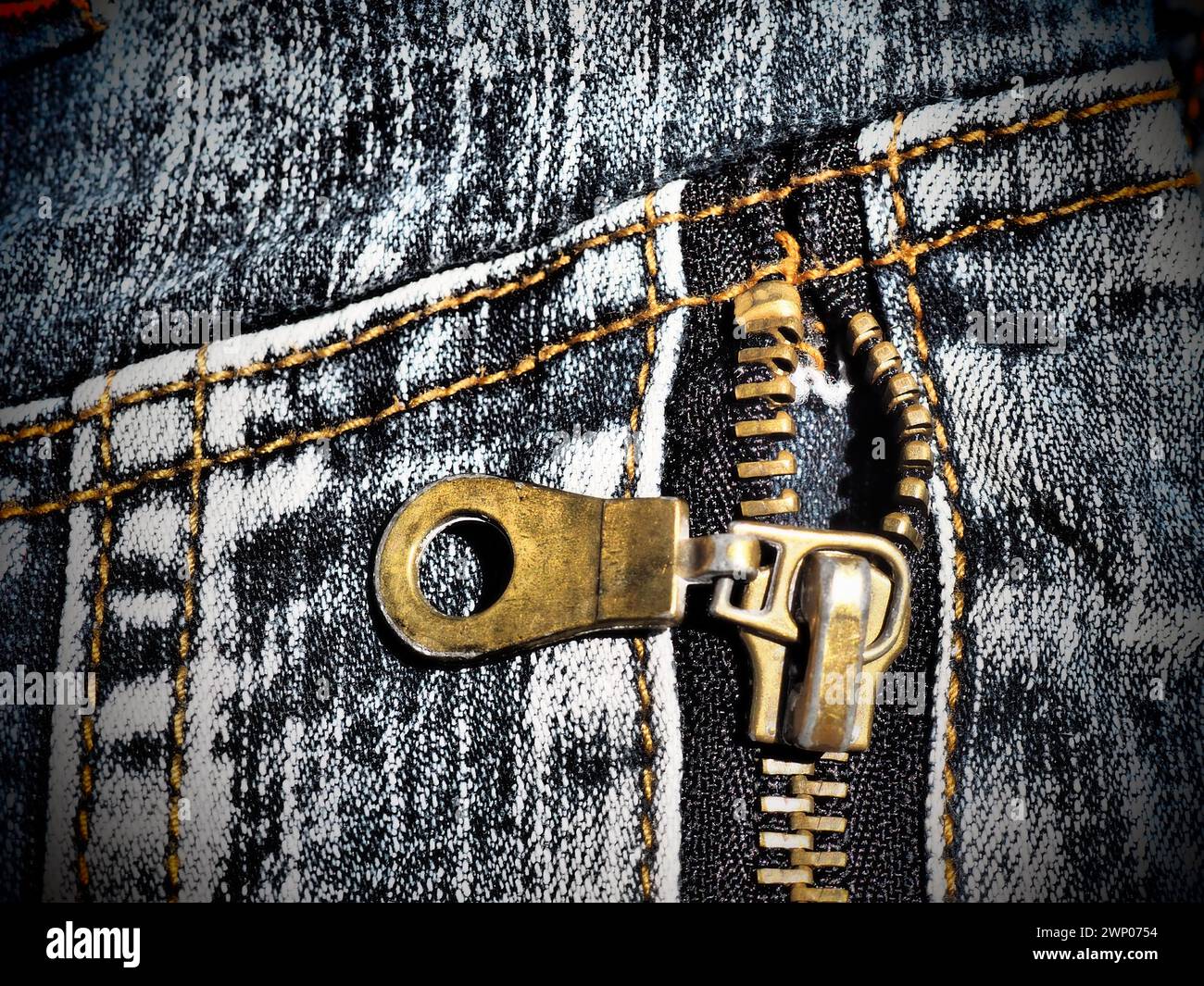 Close-up denim with seams and locks. Heavily shabby worn jeans. Metal ...