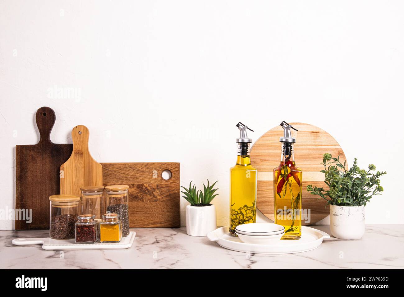 Stylish kitchen background with spice jar set, wooden cutting boards ...