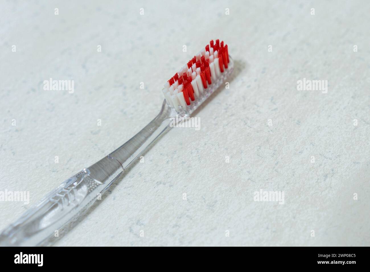 Closeup of red and white plastic toothbrush head isolated on a white ...
