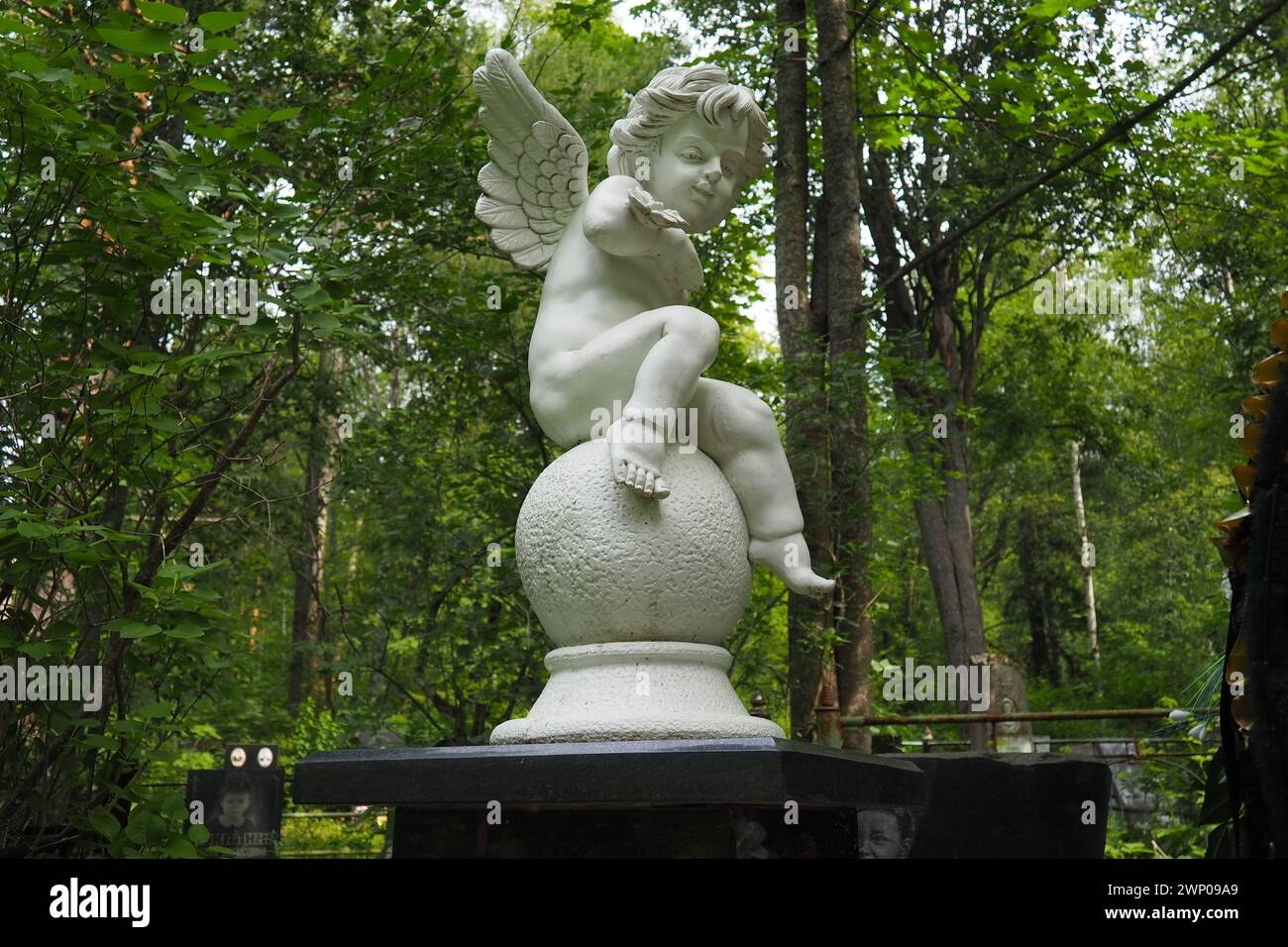 Angel in the cemetery monument at the grave of a child sculpture in the ...