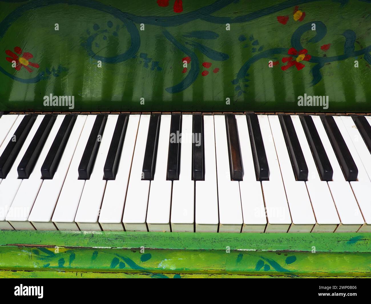 Octaves, white and black keys on a piano or grand piano. Green deck ...