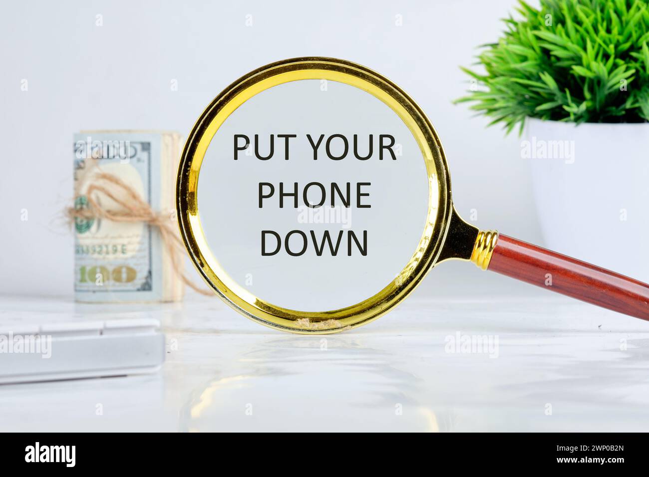 Put Your Phone Down text written through a magnifying glass on a light ...