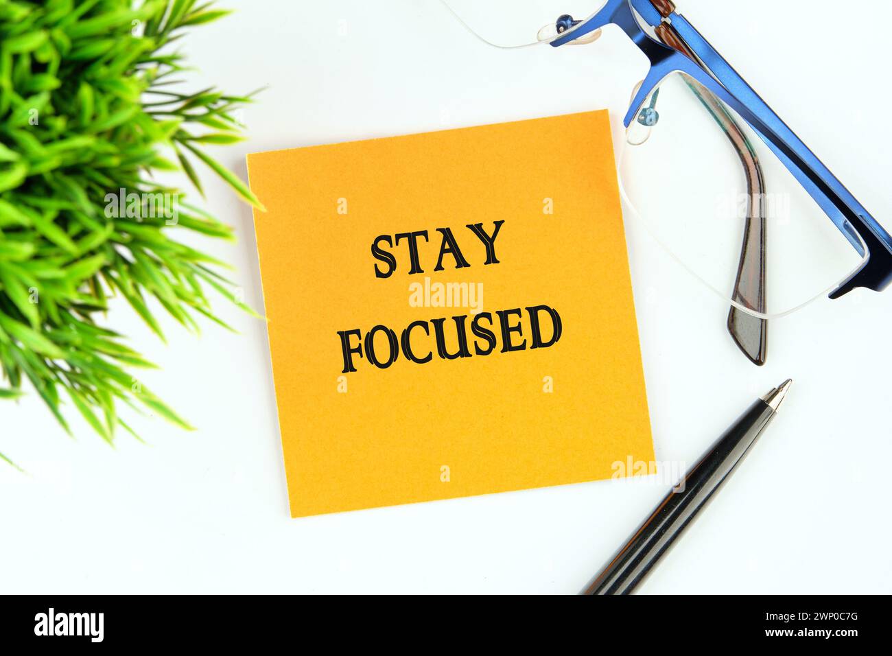 Motivation concept. STAY FOCUSED written on an orange sticker on a ...