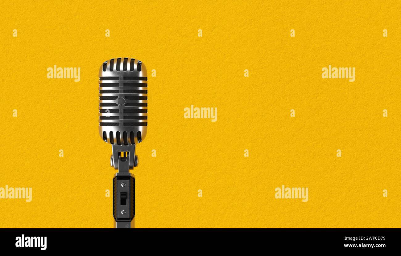 Retro style vintage microphone against yellow textured wall background ...