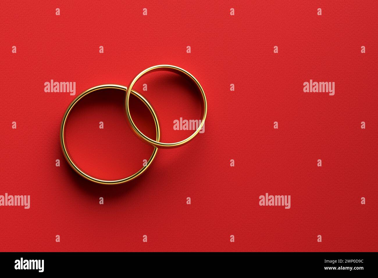 Golden wedding rings on red background. Marriage, engagement, love and ...