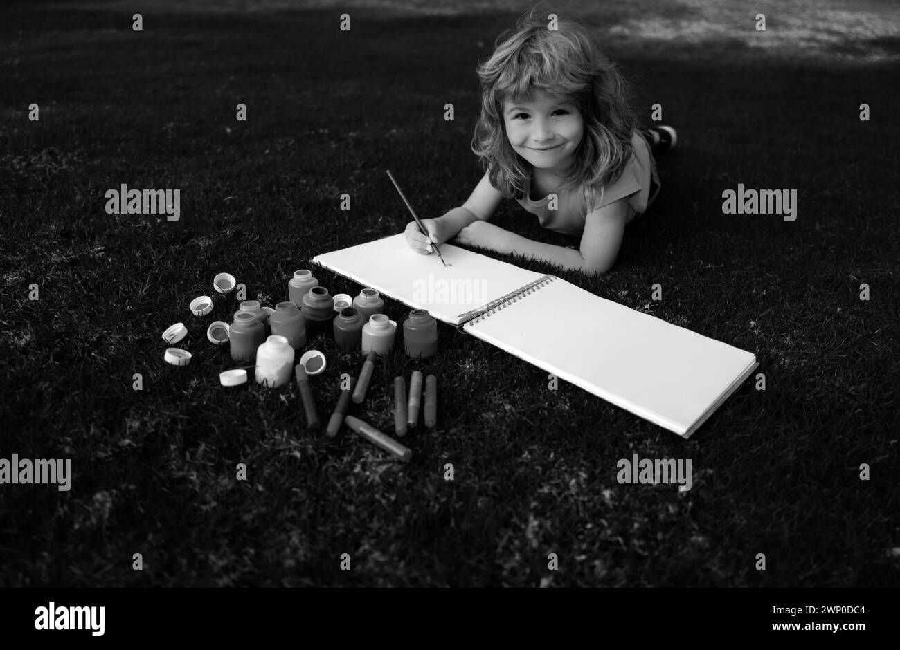 Kids painting with paints color and brush in park outdoor. Happy child ...