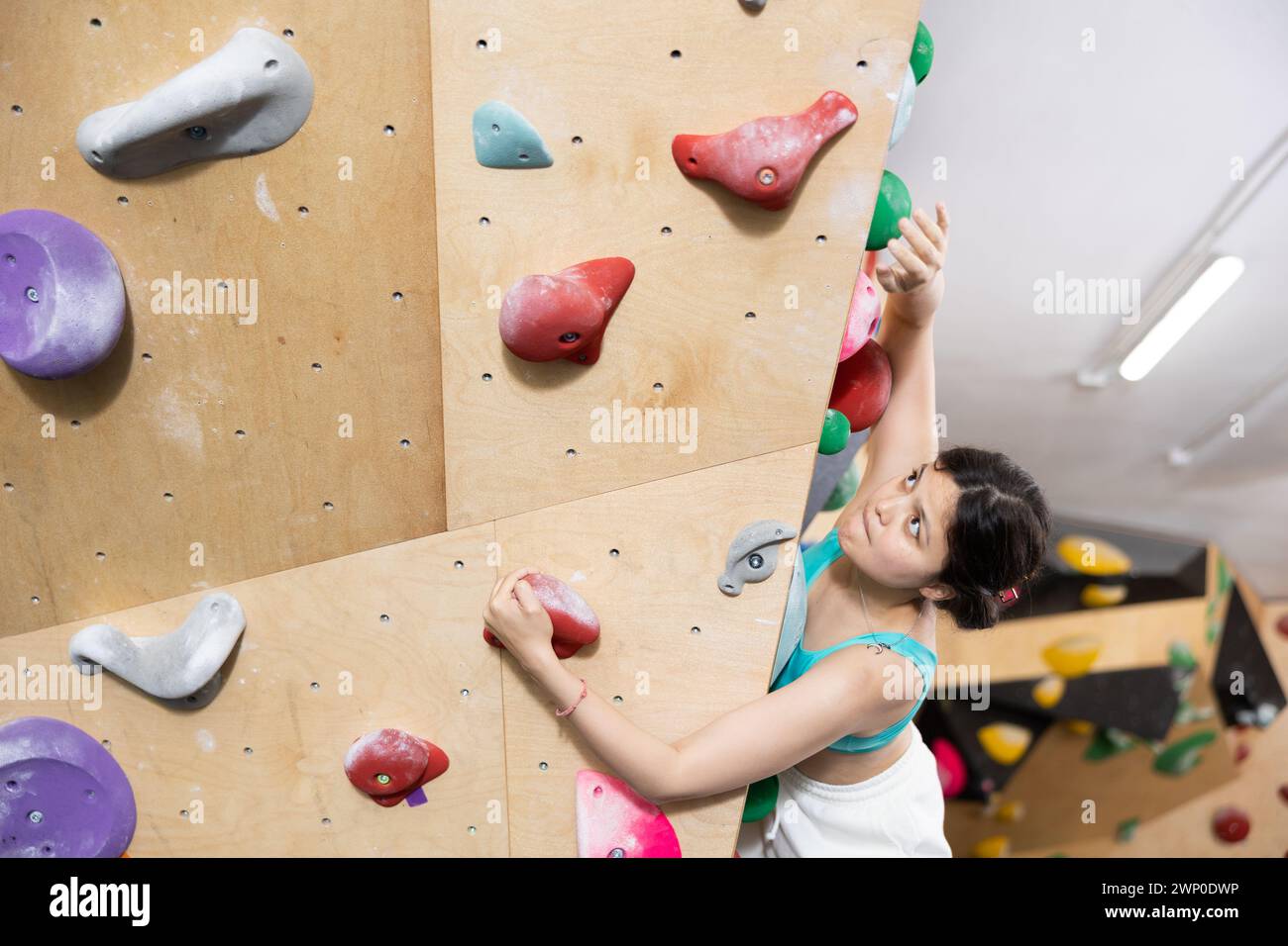 Asian female client of fitness room trains doing exercises on ...