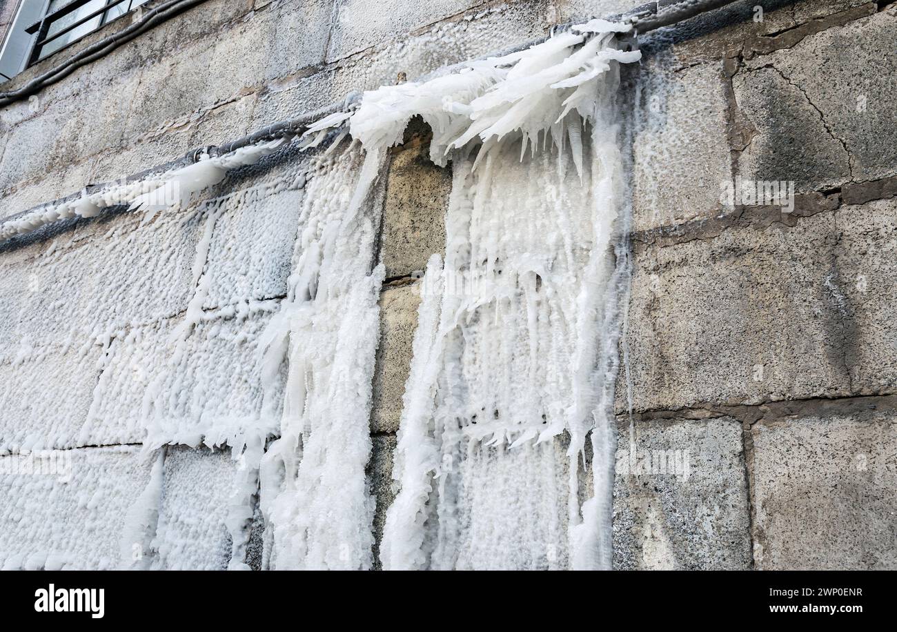 Frozen water after burst from a pipe at the winter Stock Photo - Alamy