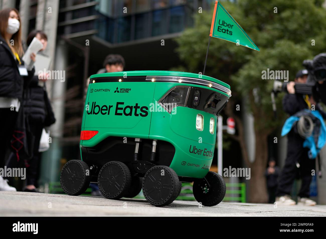 An Uber Eats food delivery robot moves on a pavement during its ...