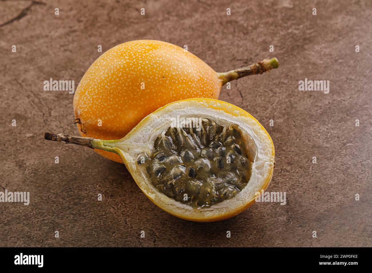 Yellow granadilla fruit with cut half Stock Photo - Alamy