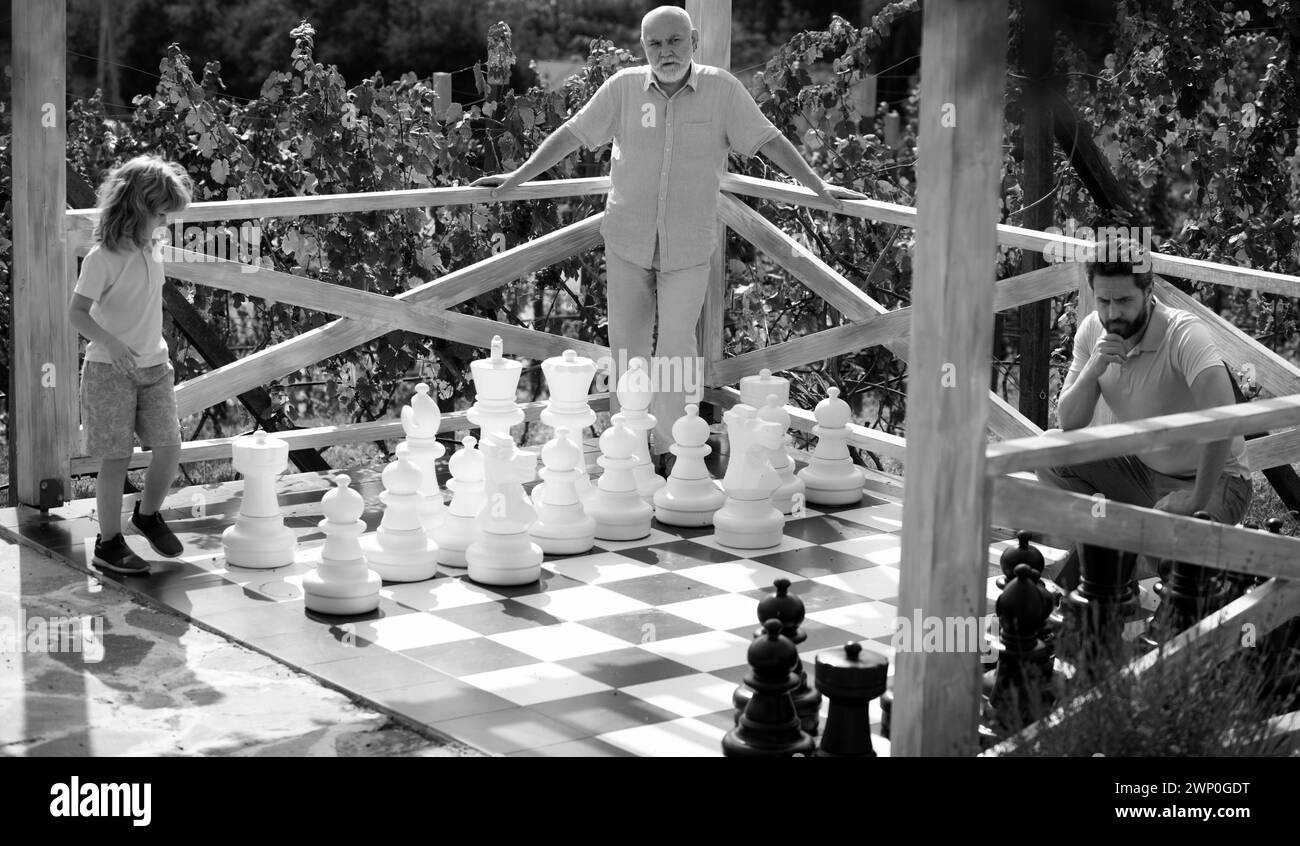 Happy generations of men have fun and playing chess. Fathers day ...