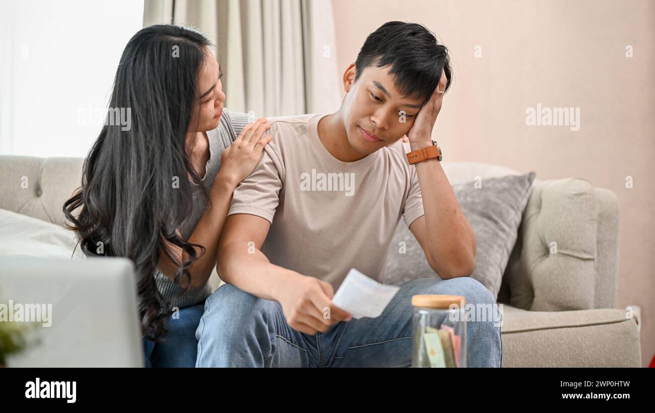 A caring young Asian woman is supporting and encouraging her stressed ...