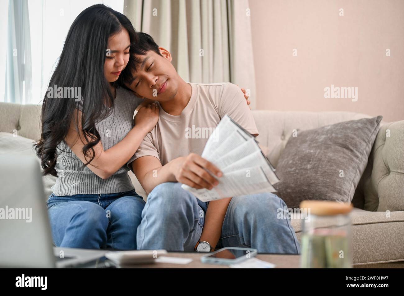 A caring young Asian woman is supporting and encouraging her stressed ...