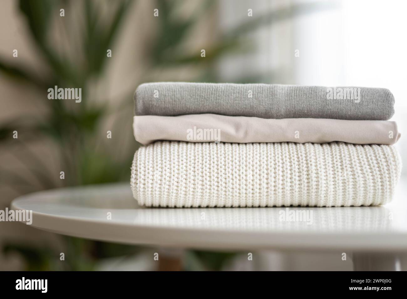 A neat stack of clean knitwear in neutral colors. Concept of ...