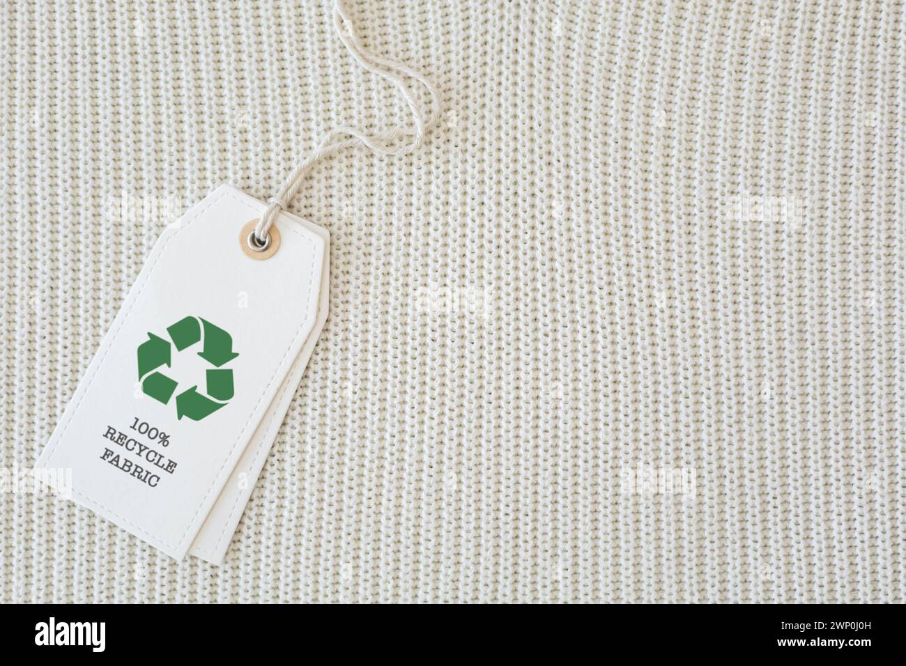 White knitted clothing with a white label that says 100% recyclable ...