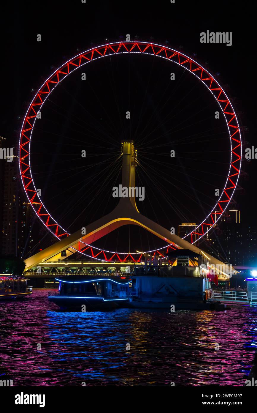 Night view of the illuminated Tianjin Eye ferris wheel in Tianjin ...