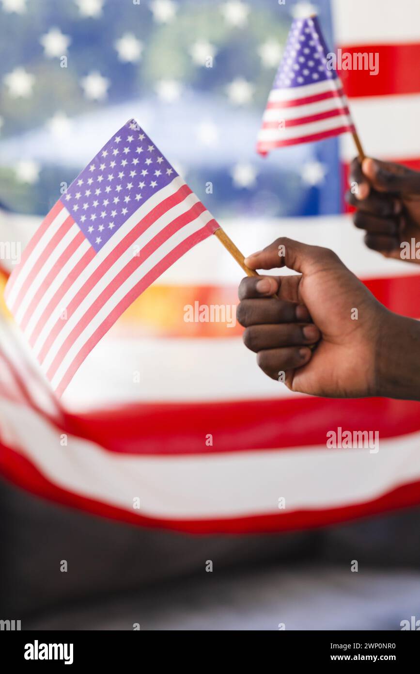 Two hands wave small American flags against a blurred background Stock ...
