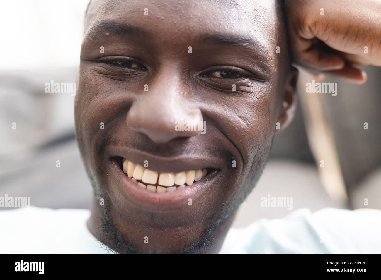 Young African American man with a beaming smile, showcasing white teeth ...