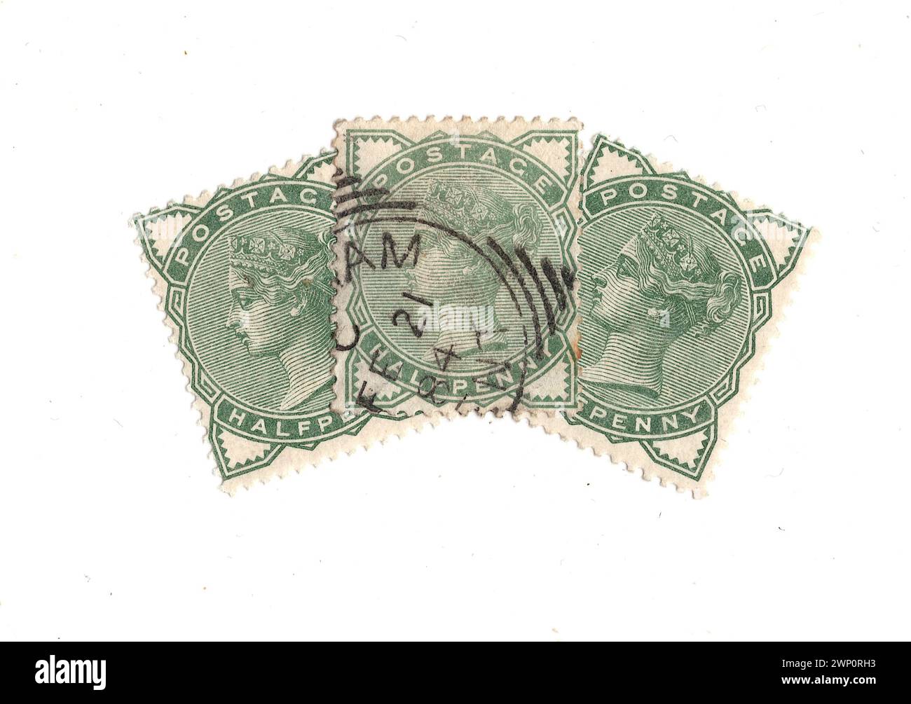 A montage of vintage Queen Victoria halfpenny postage stamps from Great Britain isolated on a ...