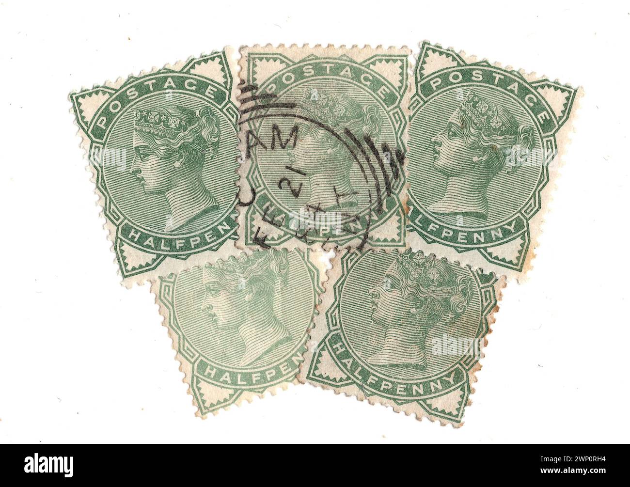 A montage of vintage Queen Victoria halfpenny postage stamps from Great Britain isolated on a ...