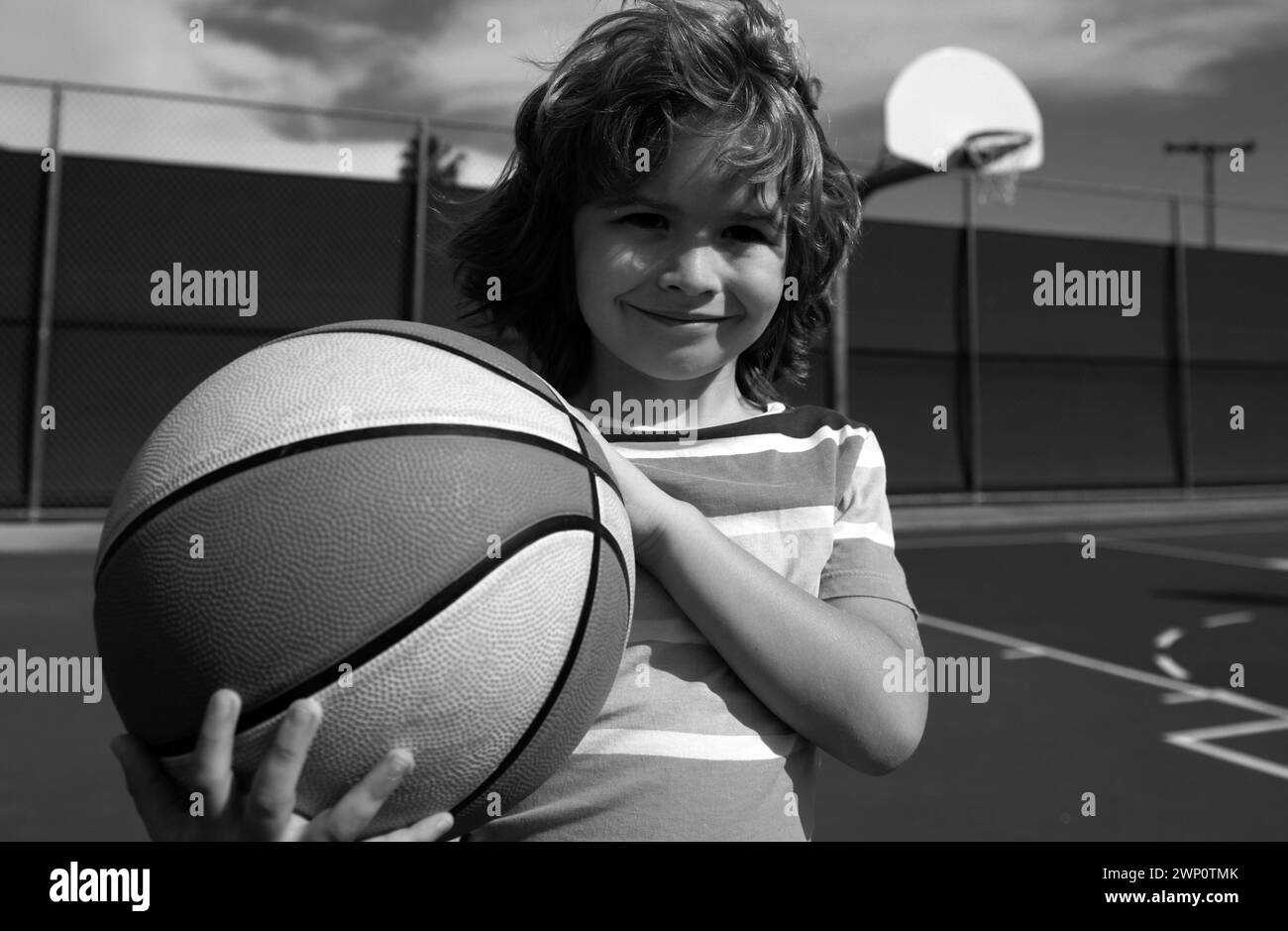 Cute smiling boy plays basketball. Active kids enjoying outdoor game ...