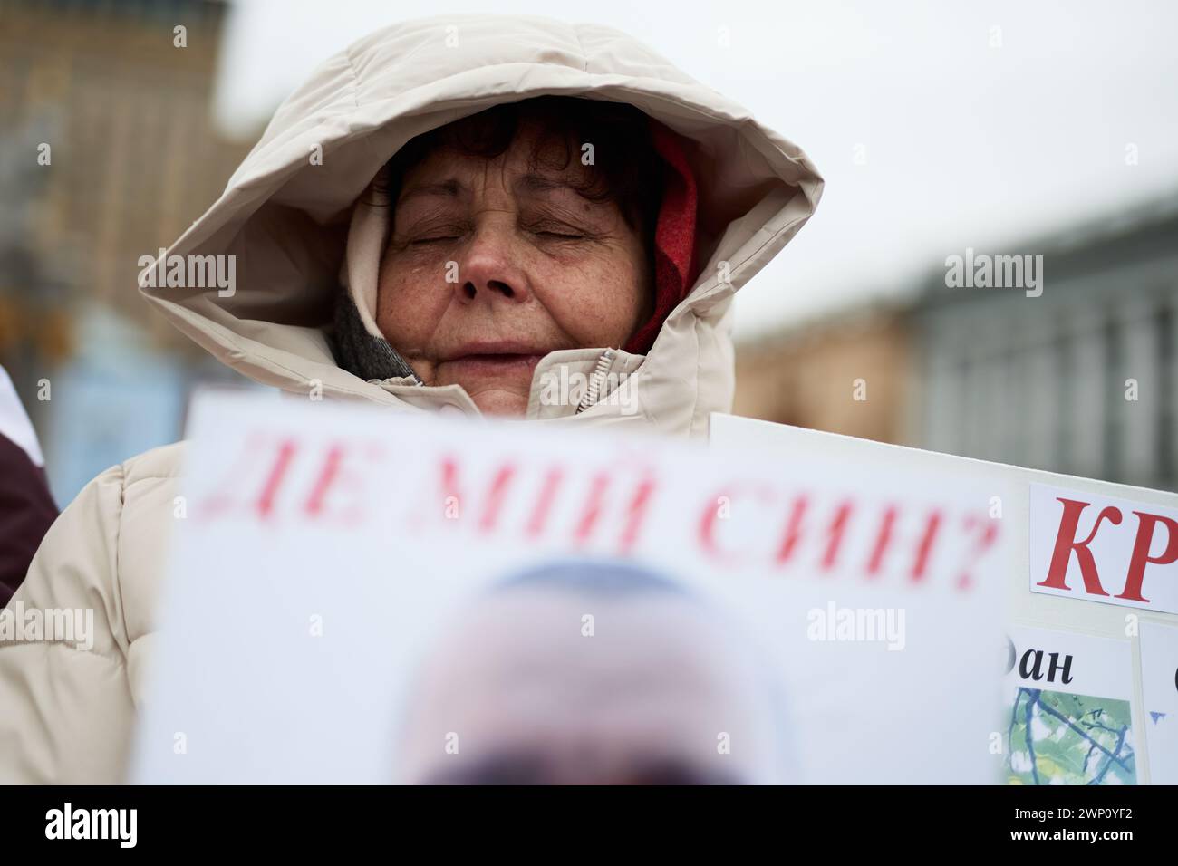 Senior Ukrainian woman crying at the public demonstration while holding ...