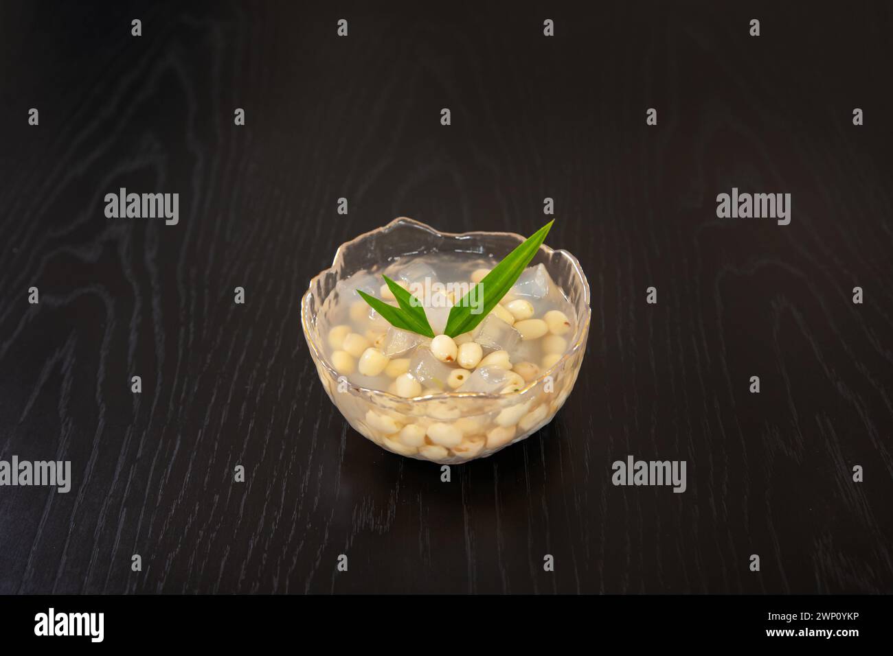 Lotus seed sweet soup isolated on black wood table background Stock ...
