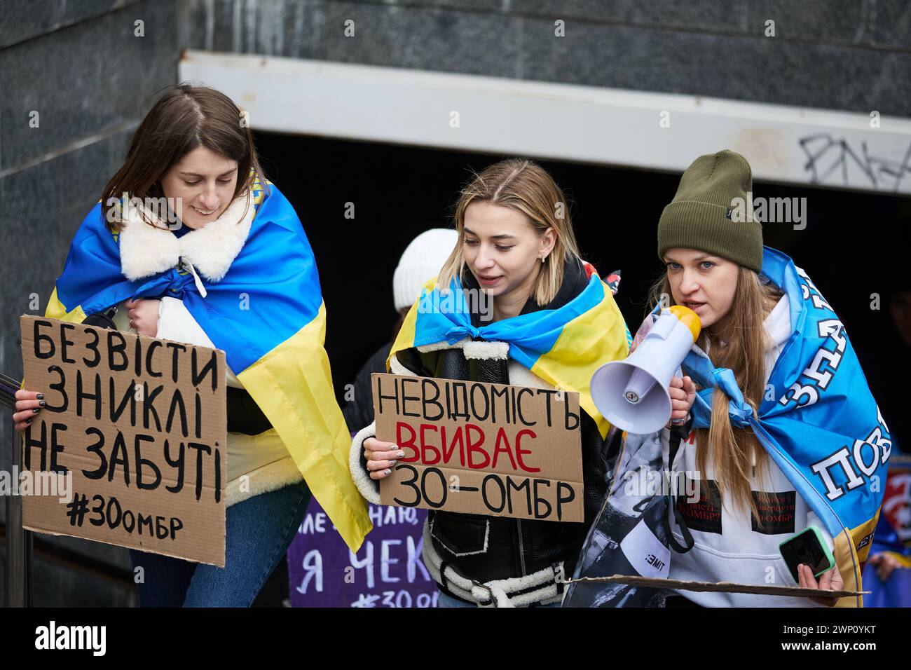 Ukrainian activists walking with banners "Missing But Not Forgotten ...