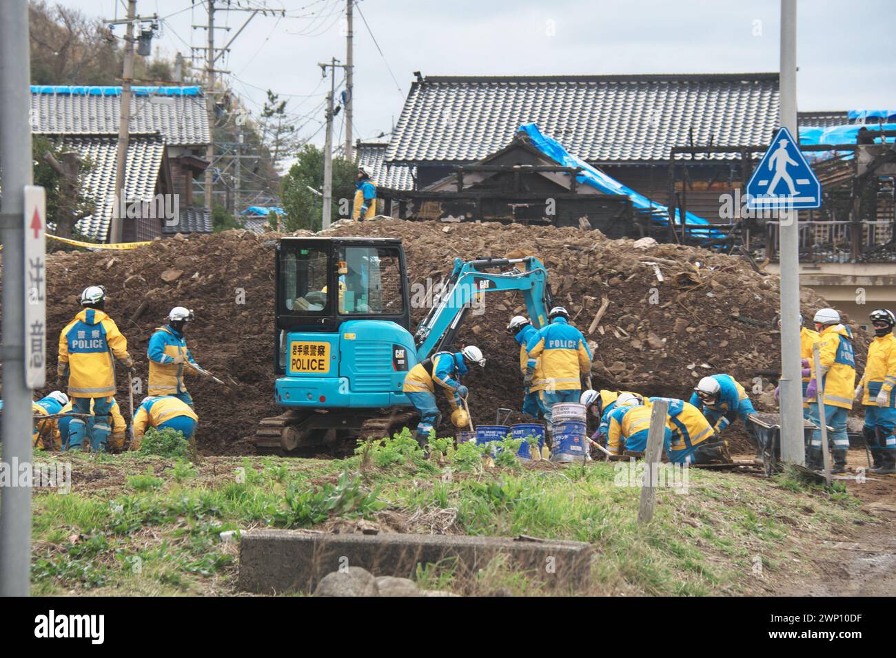 Police officers search for a missing person in Wajima, Ishikawa ...