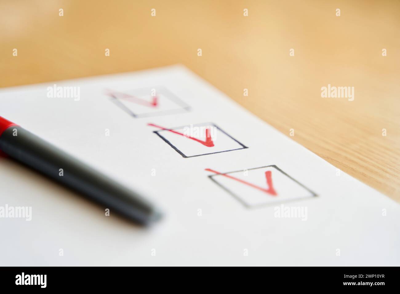 Checklist marked red with a red pen Stock Photo - Alamy