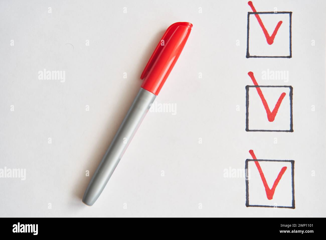 Checklist marked red with a red pen Stock Photo - Alamy
