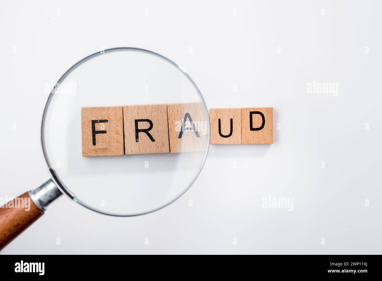 Fraud sign with magnifying glass Stock Photo - Alamy
