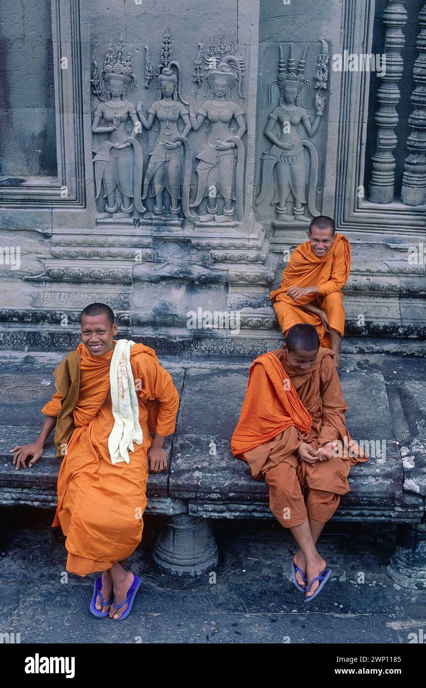 Smiling monks by reliefs of dancing apsaras, Angkor Wat temple, taken ...