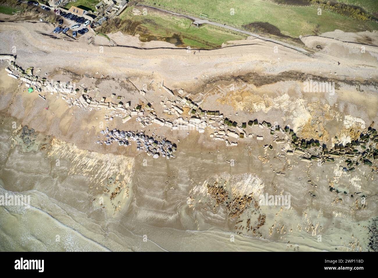 Aerial view of Climping beach in West Sussex and the broken sea defence ...